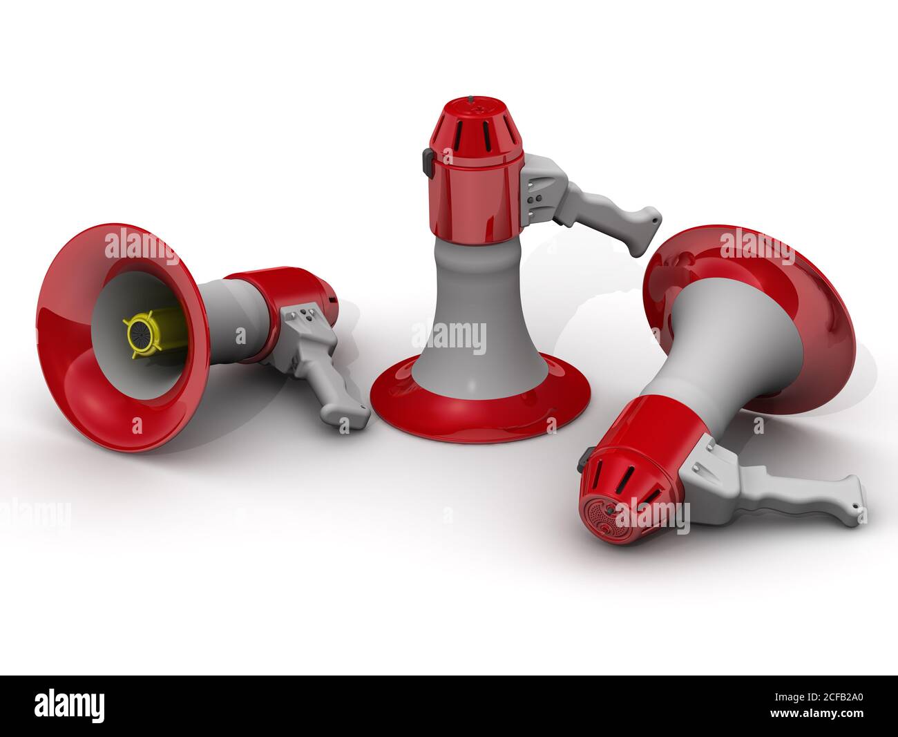 Megaphones lie on a white surface. Three red megaphone (electric horn ...