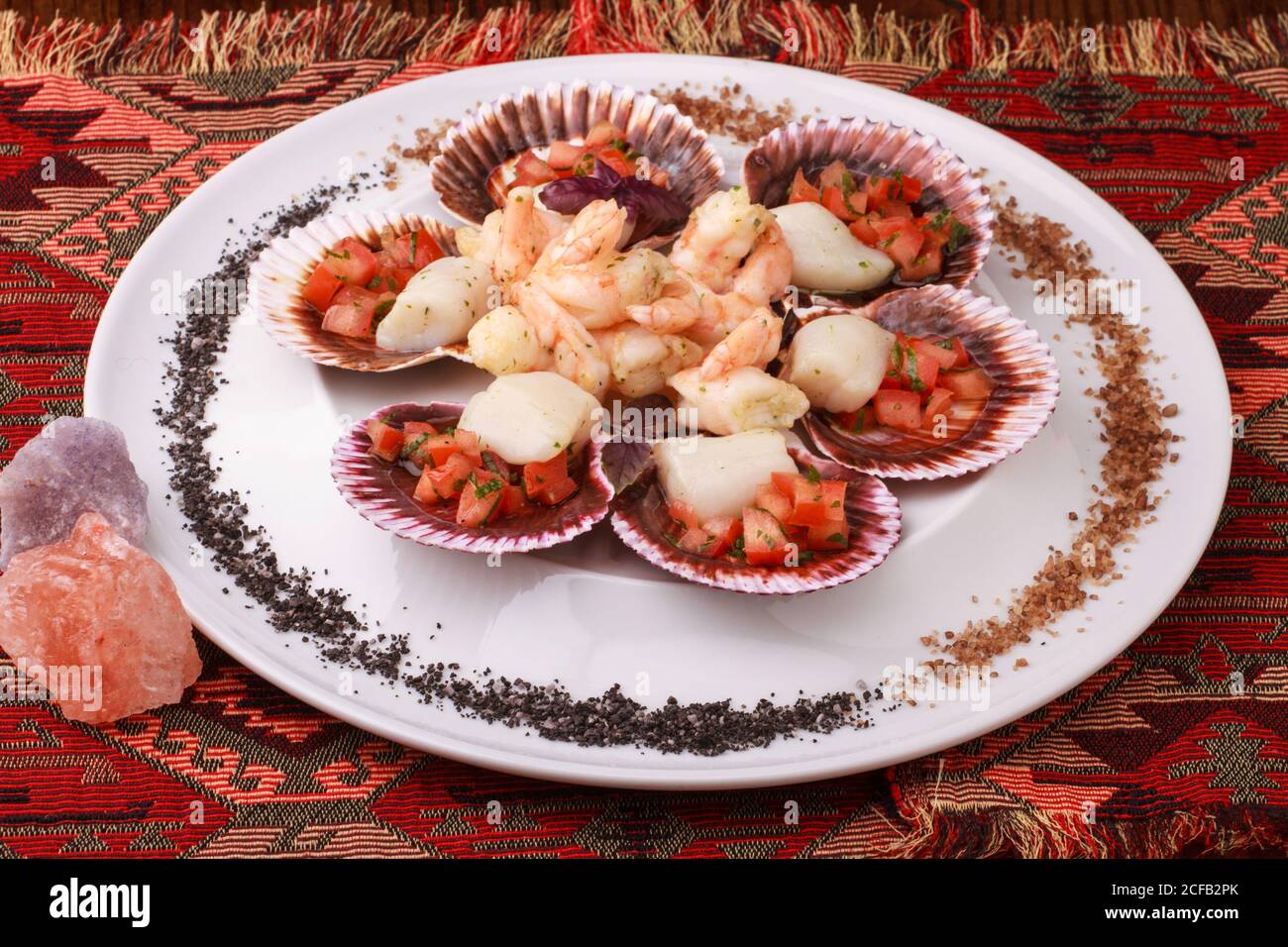 Mixed seafood platter (Scallops with tomato salsa and shrimp) served ...