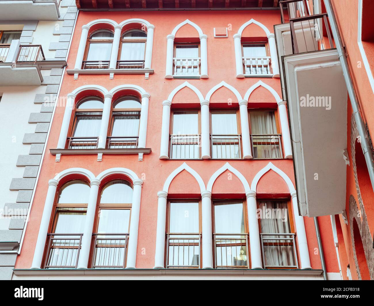Rectangular windows with arched and domed decor on a coral wall Stock ...