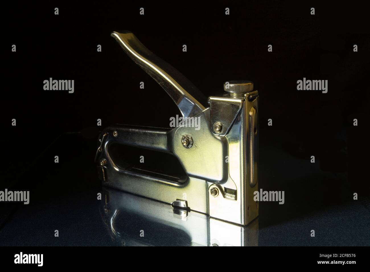 Stepler from become on table with reflection on black background ...