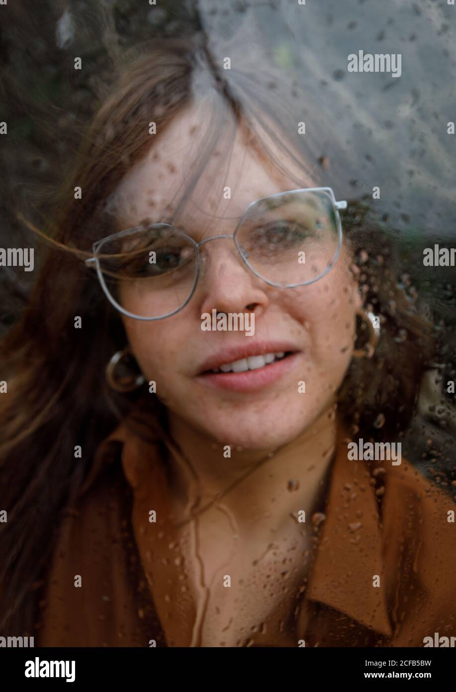 Woman looking through window rain hi-res stock photography and images ...