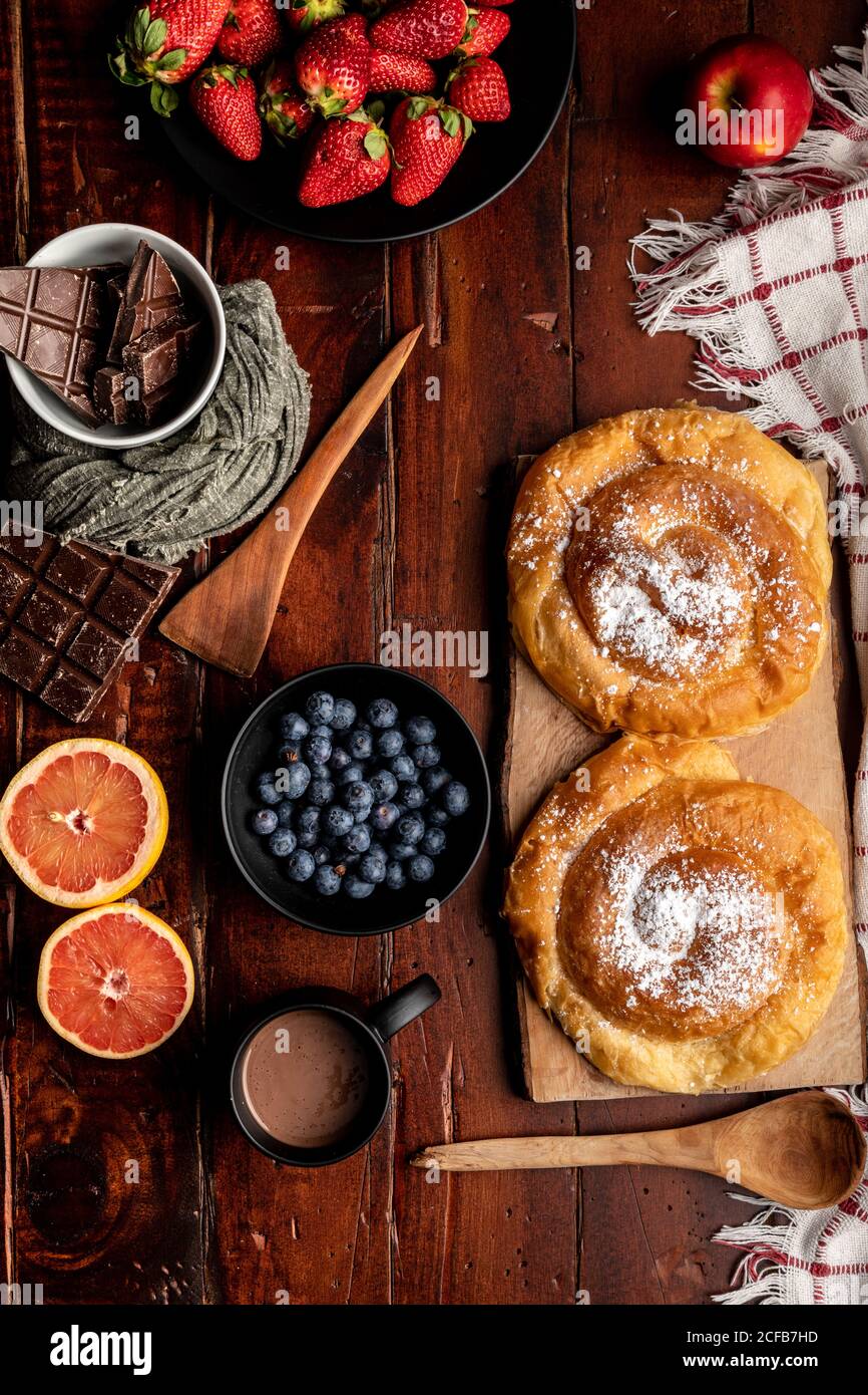 Fresh hot beverage and various tasty breakfast food placed on lumber ...