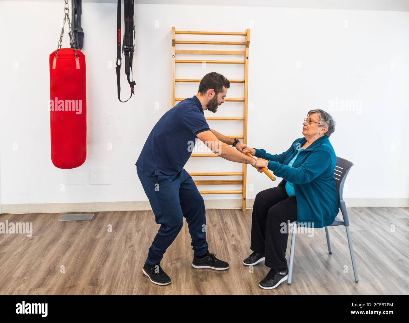 Physiotherapy with personal instructor in gym Stock Photo - Alamy
