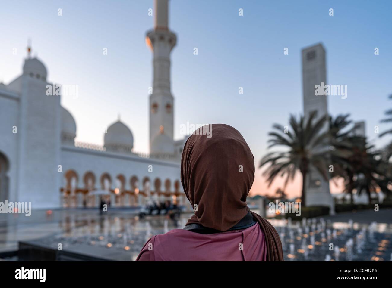 Woman in Hijab looking at a mosque at sunset | Abu Dhabi Sheik Zayed ...