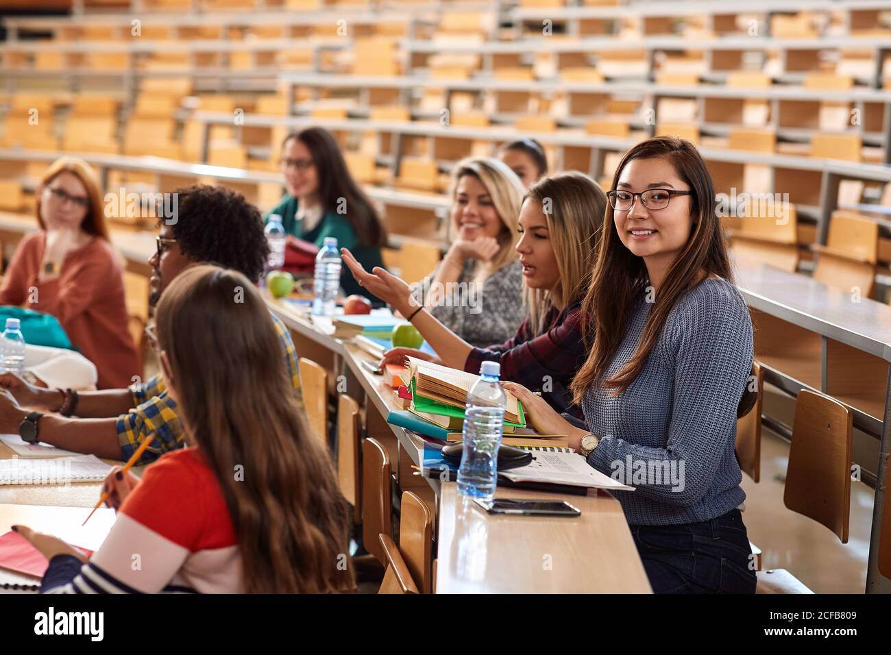 Students group together in amphitheater Stock Photo - Alamy