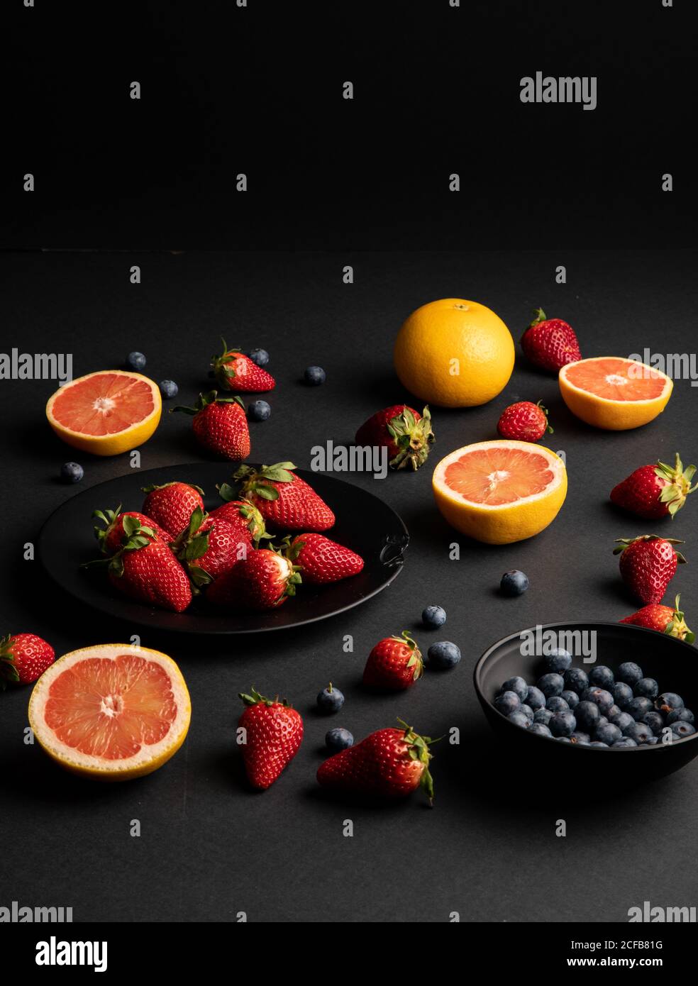 Various fresh fruits for breakfast placed on black background Stock ...