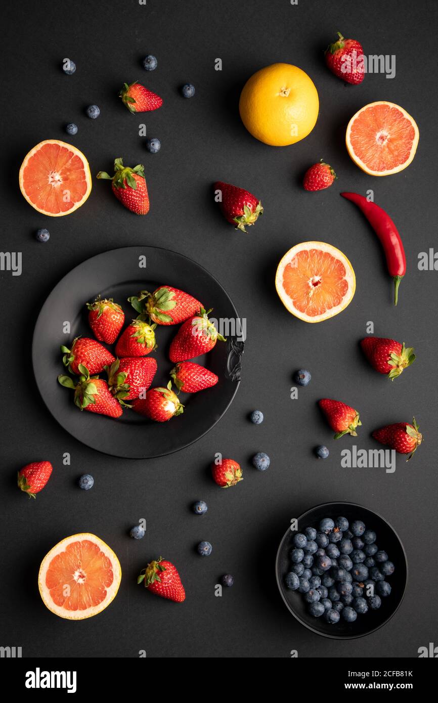 Top view of various fresh fruits for breakfast placed on black ...