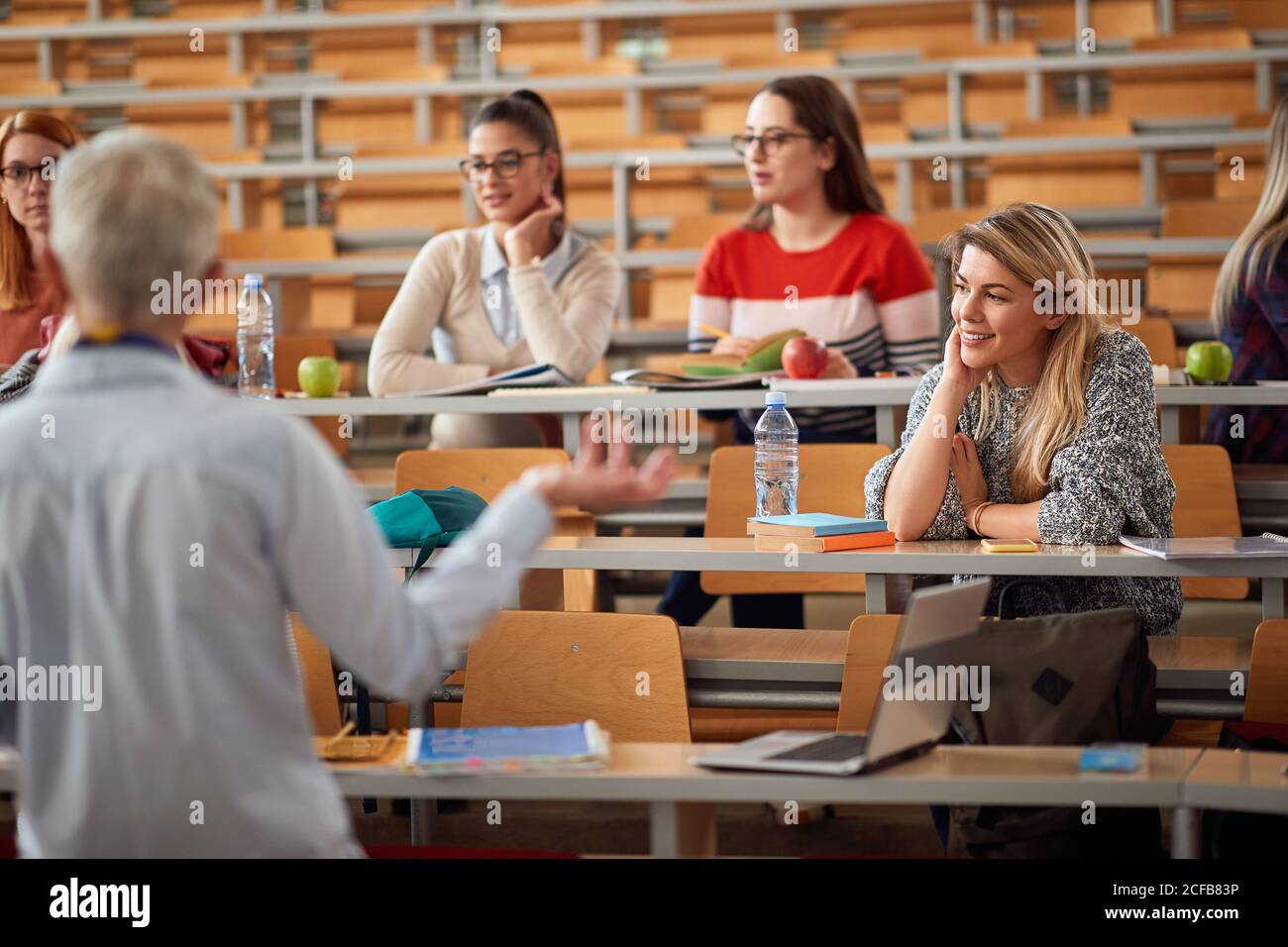 Group of students in amphitheater listening lecture Stock Photo - Alamy