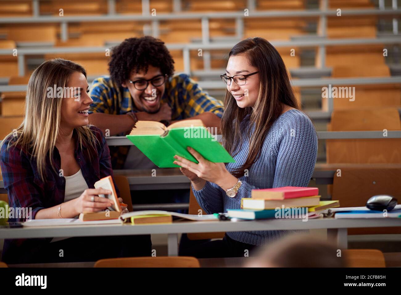 Happy students learning together in amphitheater Stock Photo - Alamy
