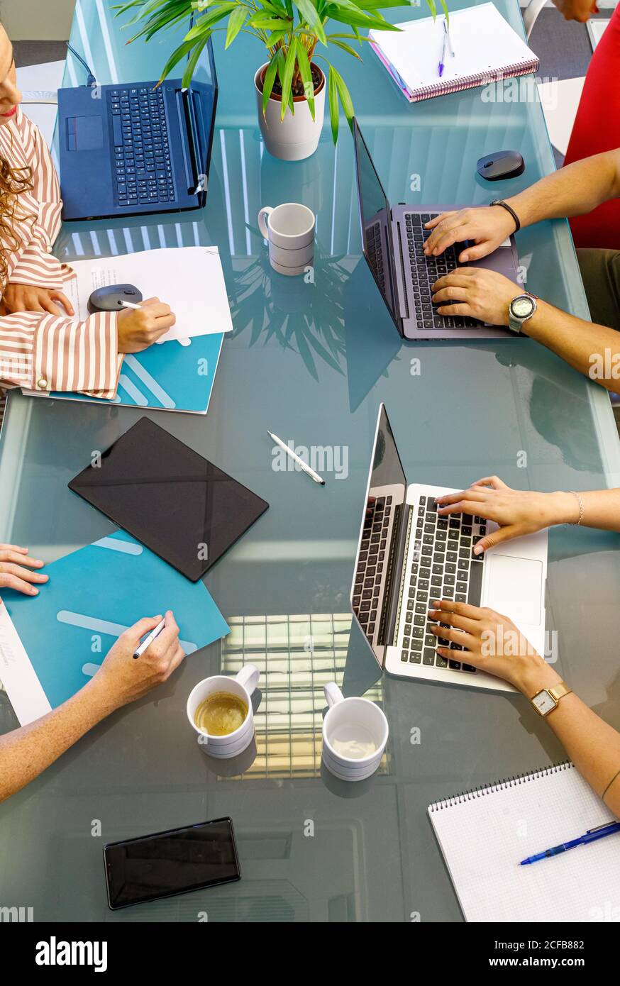 faceless colleagues working at laptops in office Stock Photo - Alamy