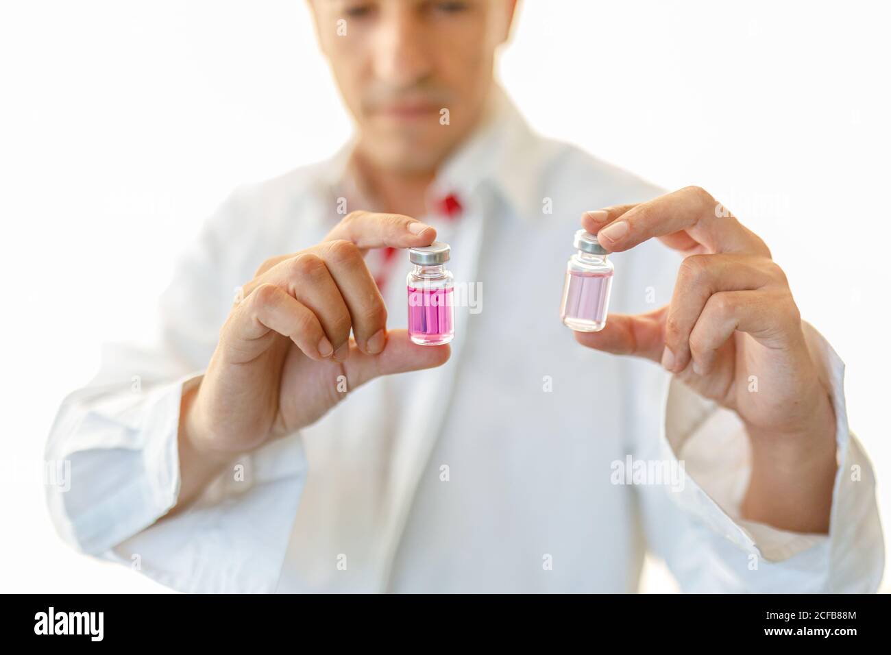 man in white lab coat studying sample Stock Photo - Alamy