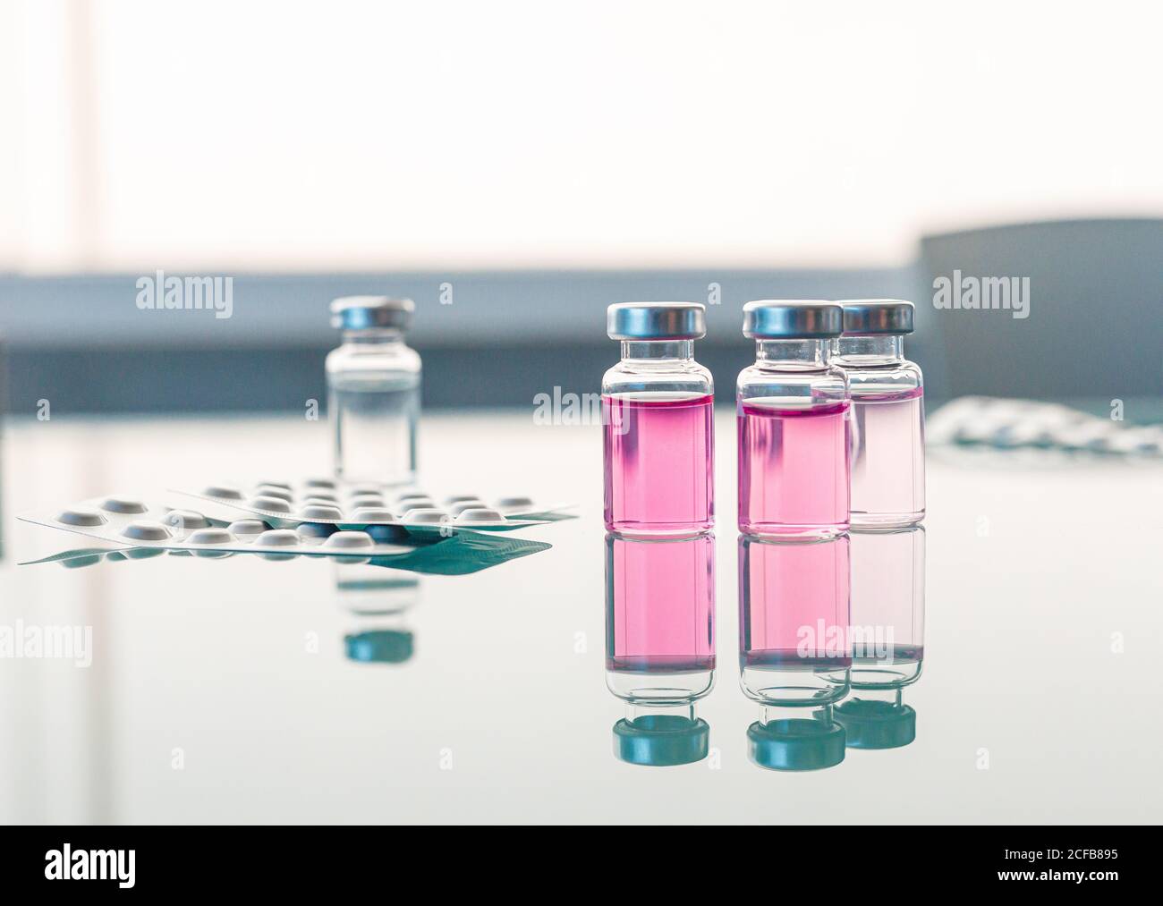 Vials with scientific samples arranged on glass table Stock Photo - Alamy