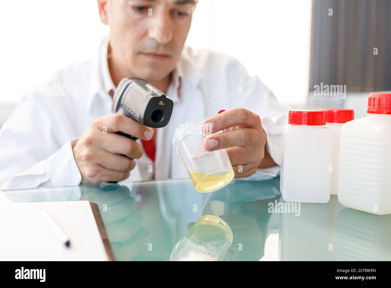Male assistant using medical device for urine test Stock Photo - Alamy
