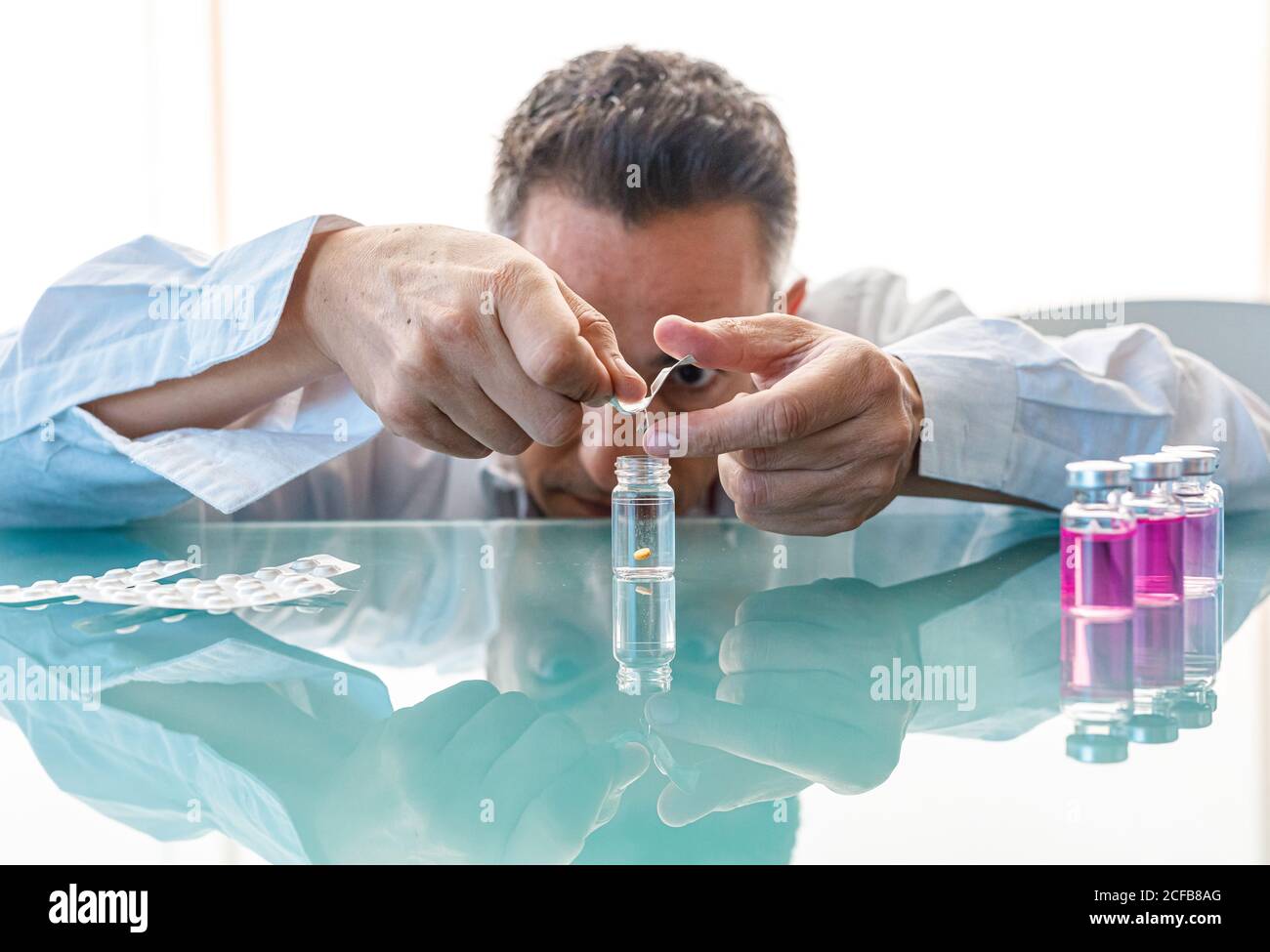 Assistant making test with samples in laboratory Stock Photo - Alamy