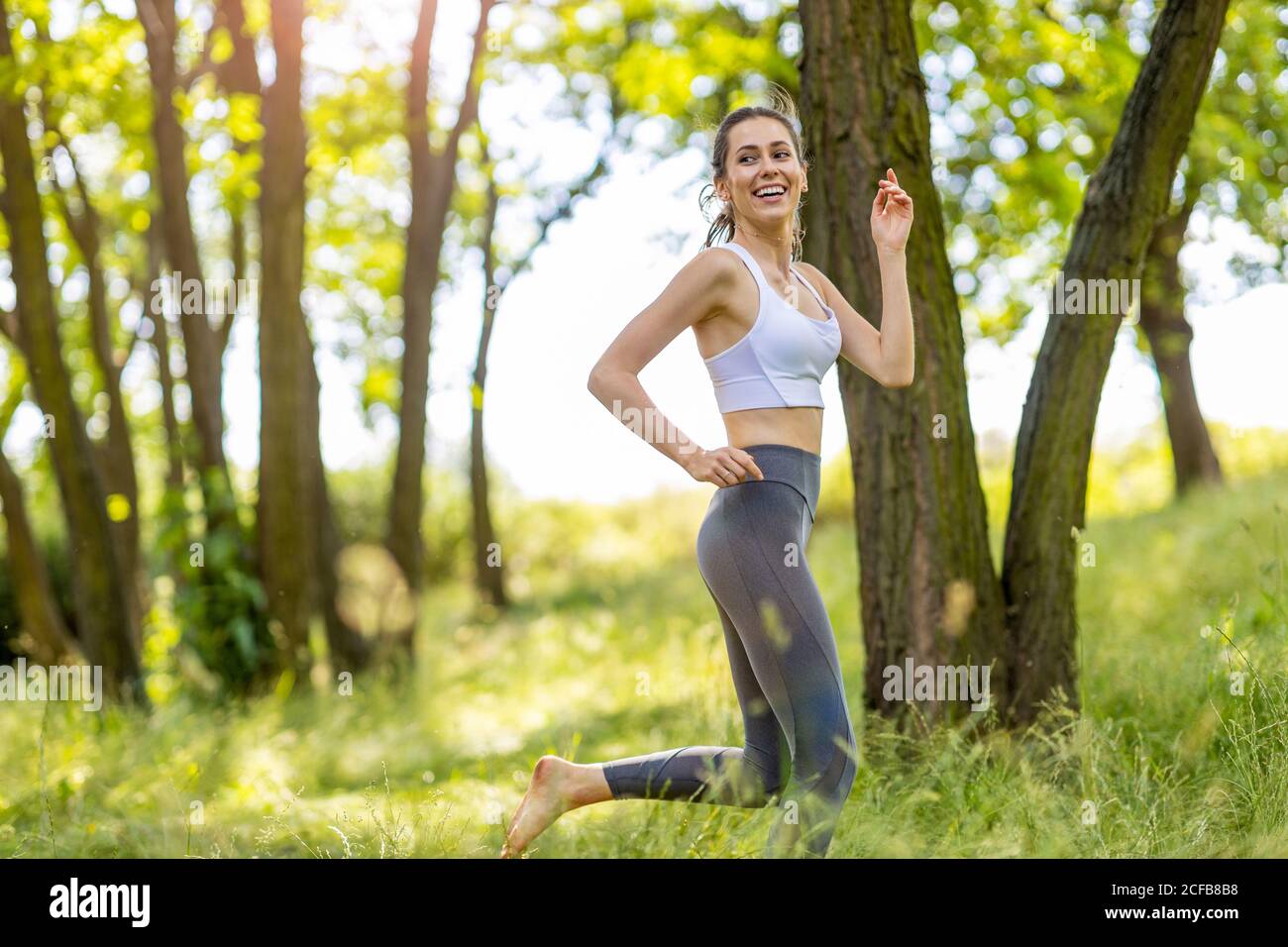 Fit young woman exercising in nature Stock Photo - Alamy