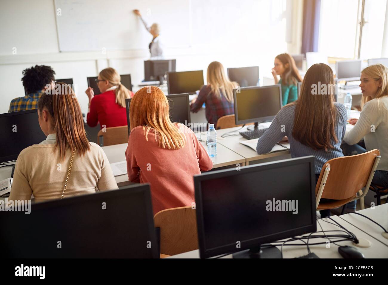 Back view of pupils in classroom on lecture Stock Photo - Alamy