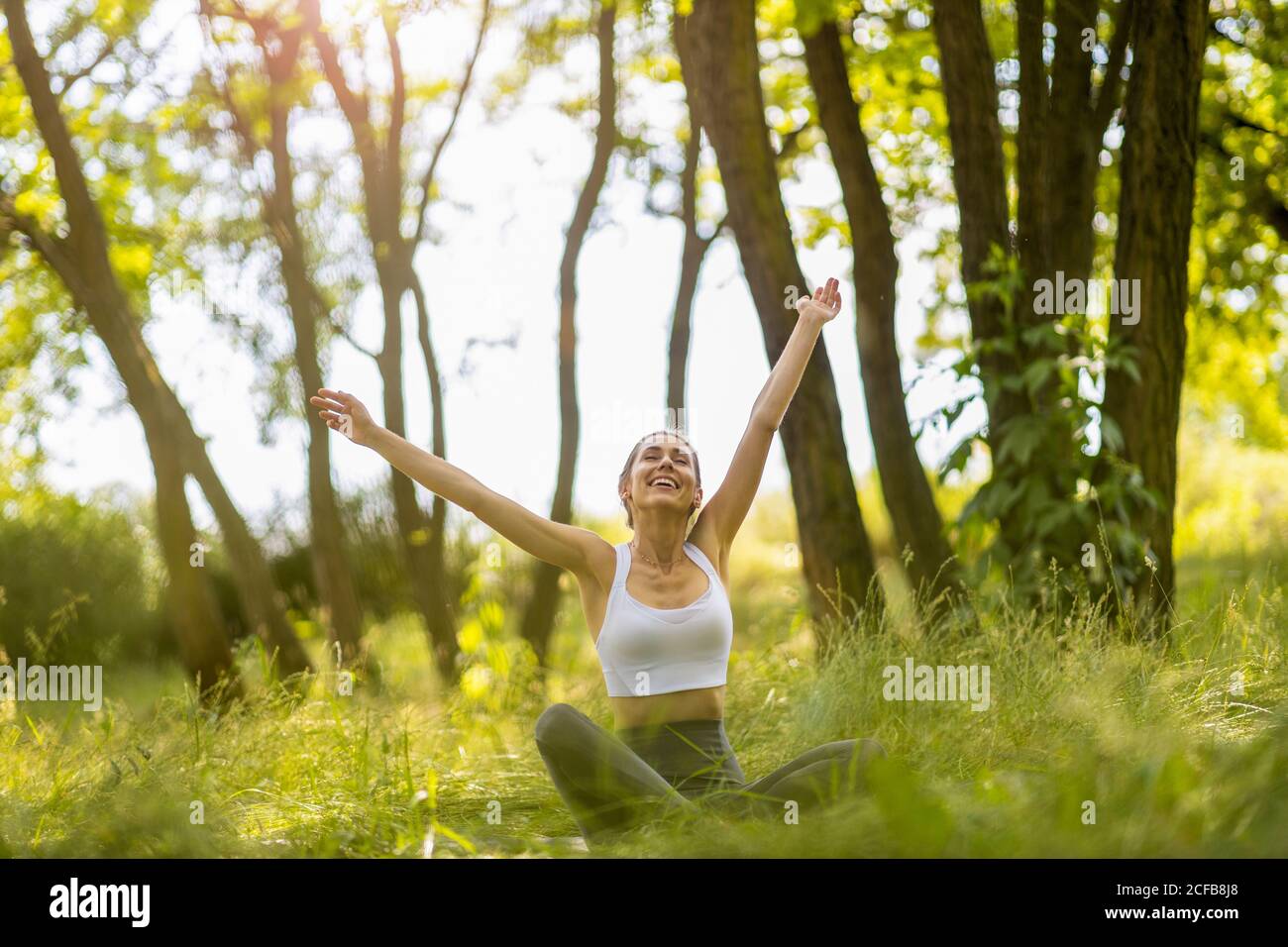Young woman sitting at the park Stock Photo - Alamy