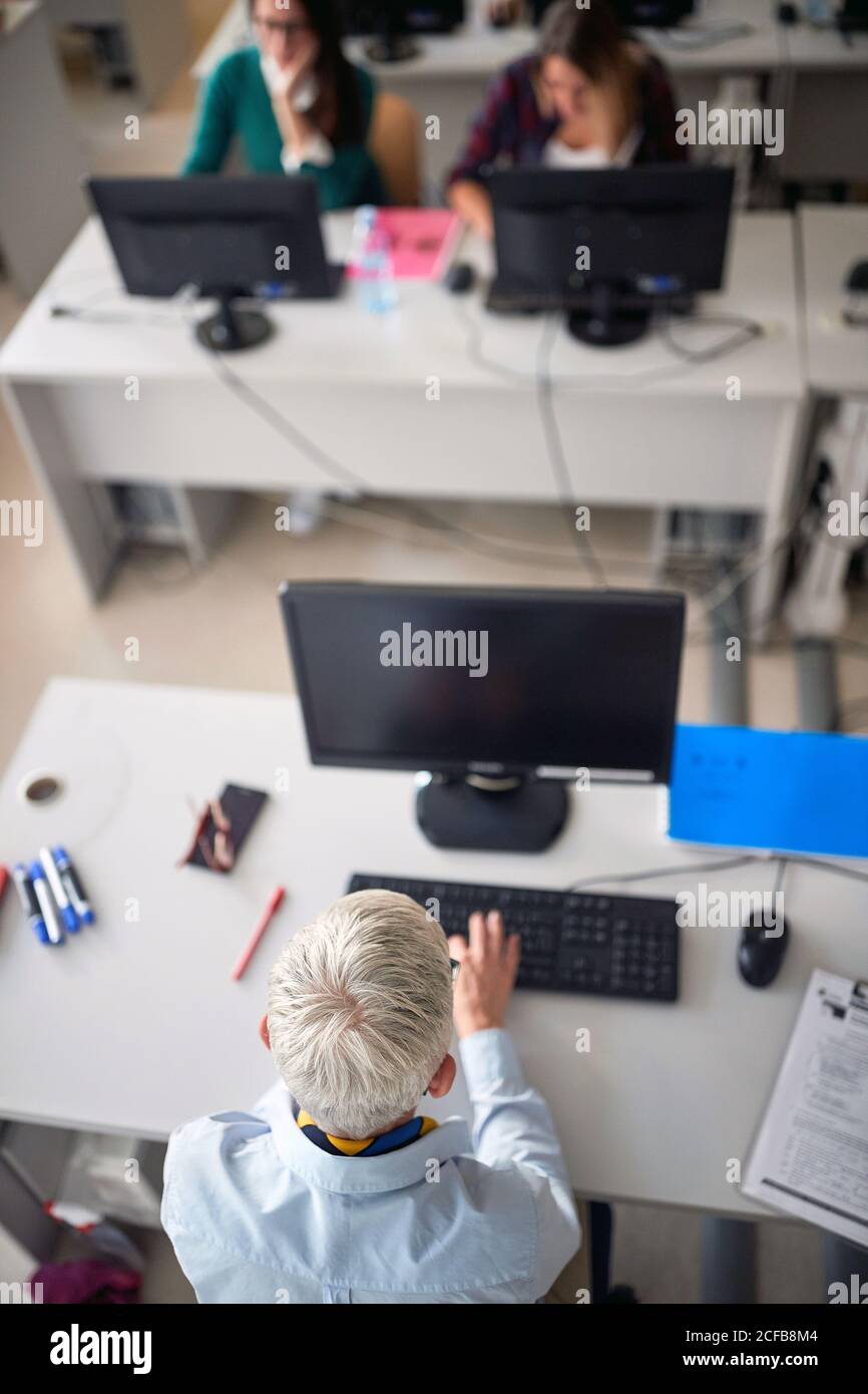 Top view of female professor with students in classroom Stock Photo - Alamy