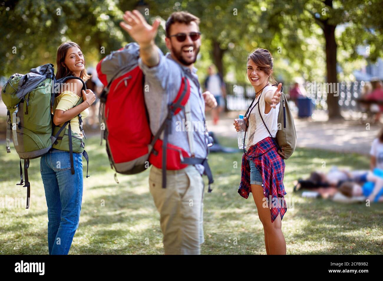 Young tourists posing in a park on a beautiful weather Stock Photo - Alamy