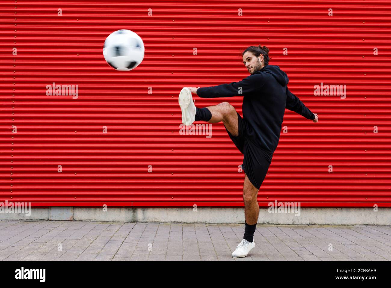 Man playing football urban hi-res stock photography and images - Alamy