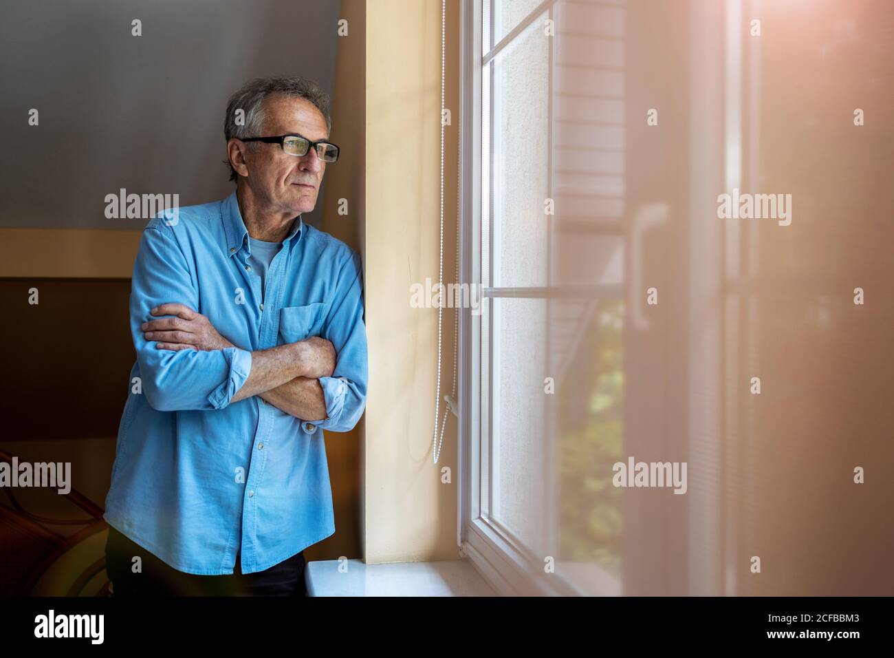 Old man looking out of window sad hi-res stock photography and images ...