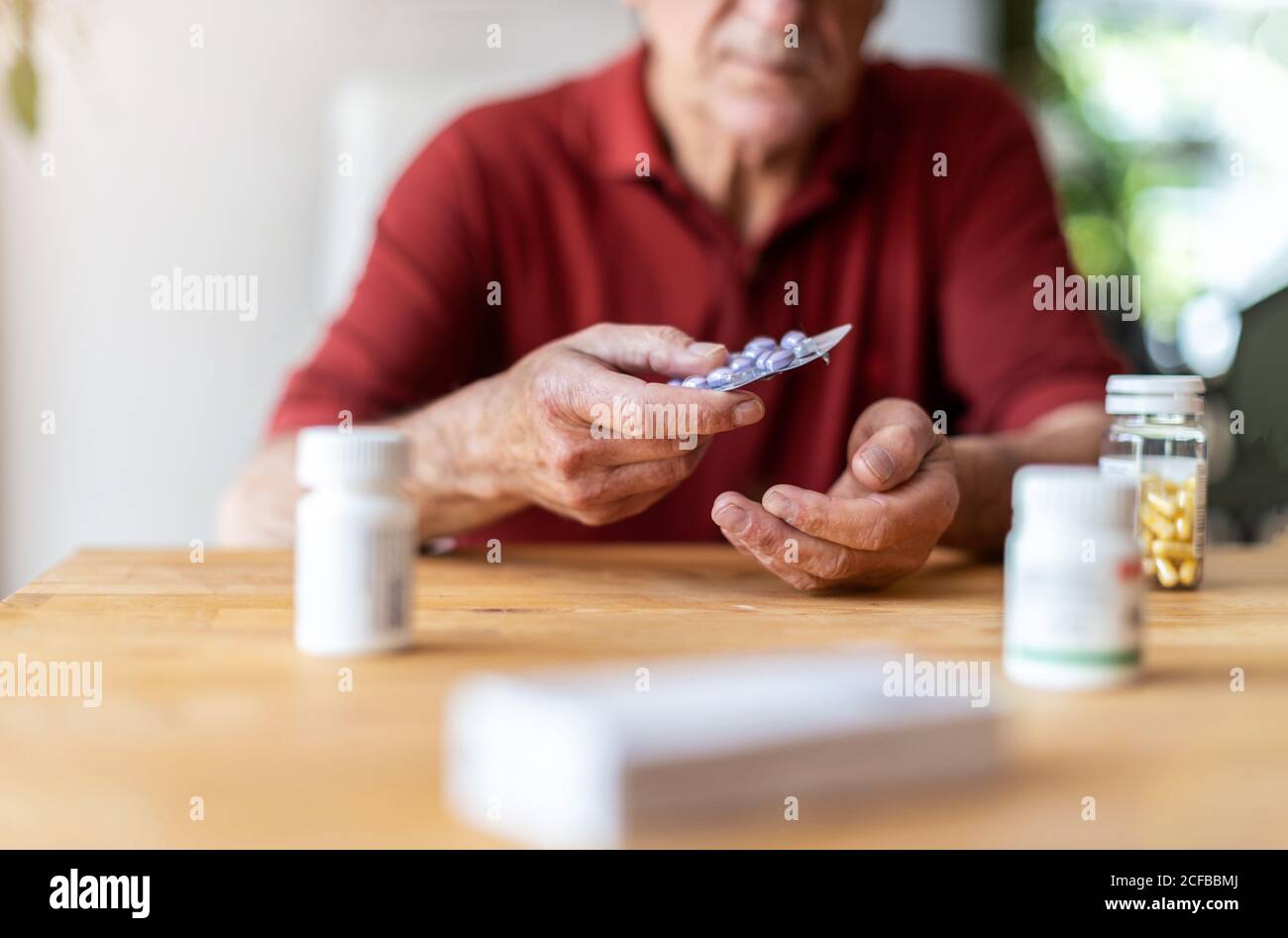 Senior man taking prescription medicine at home Stock Photo - Alamy