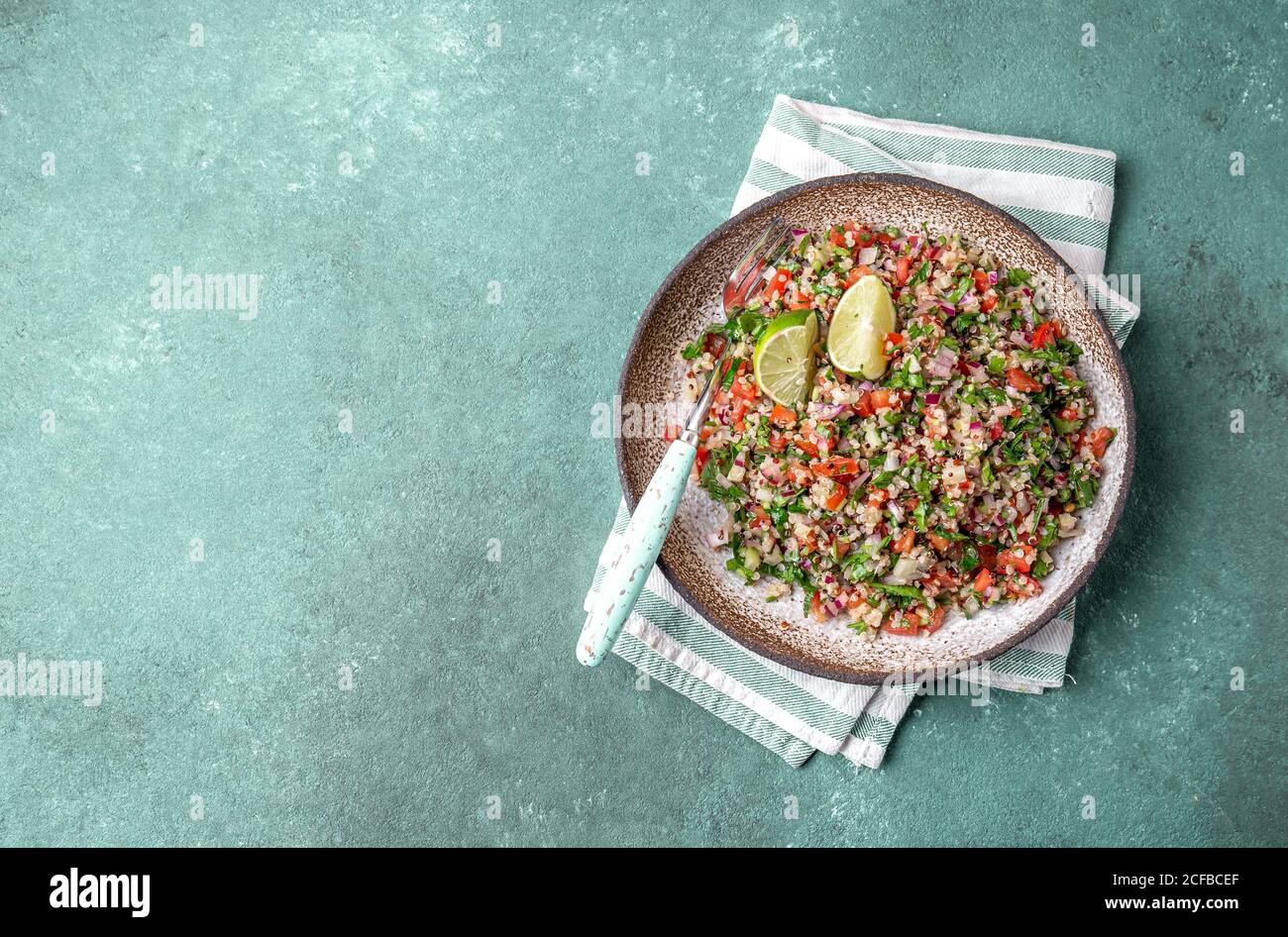 Traditional Lebanese salad tabouli tabule with quinoa, herbs, tomatoes ...