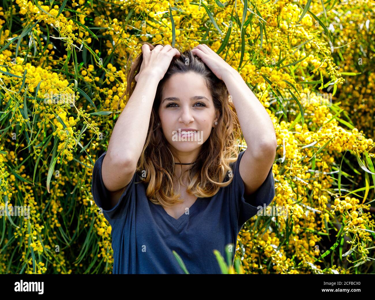 Young female near blooming bushes Stock Photo - Alamy