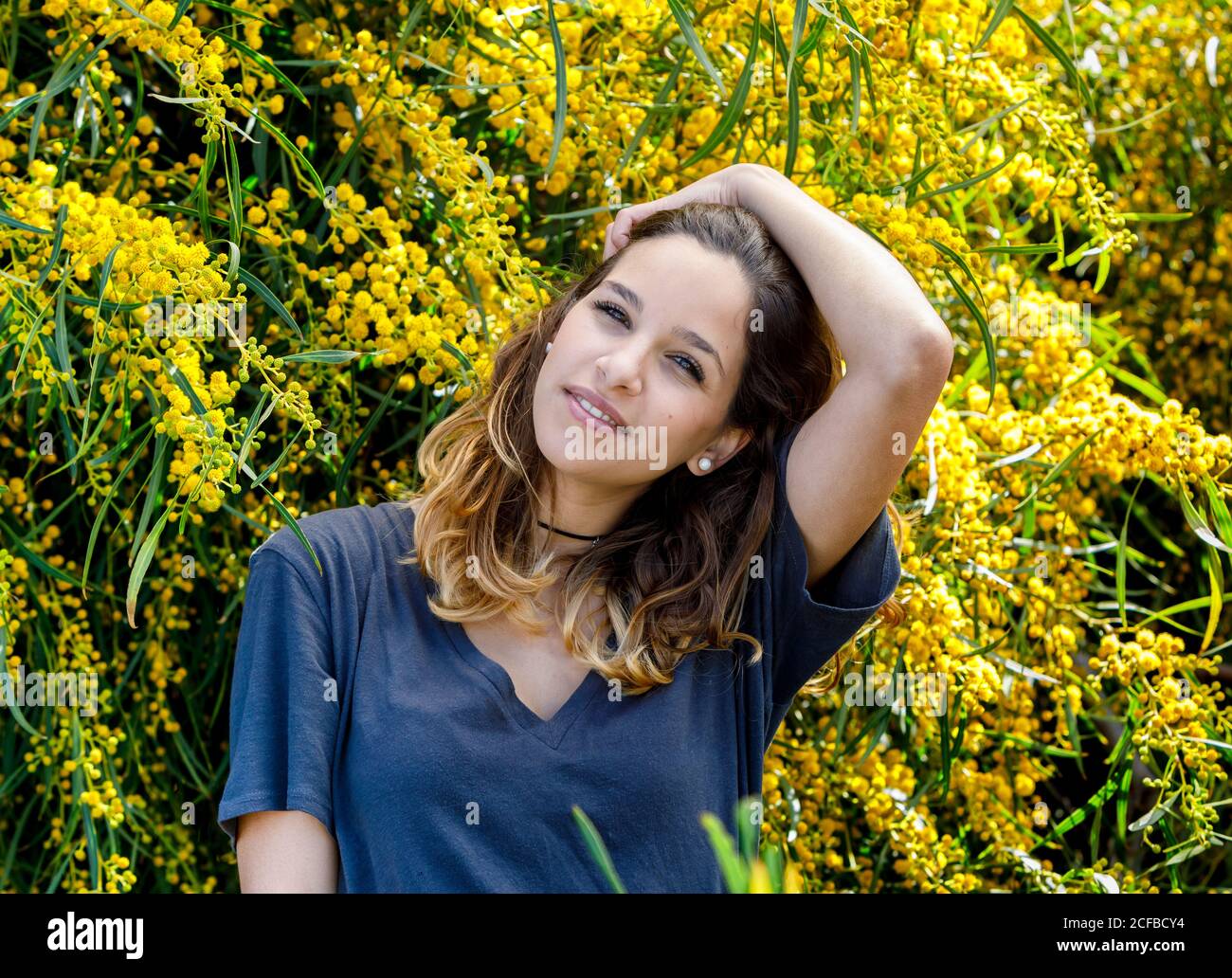 Young female near blooming bushes Stock Photo - Alamy