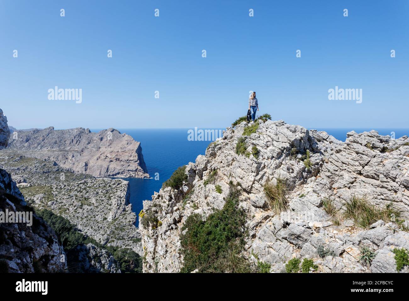Young Woman standing on cliff Stock Photo - Alamy