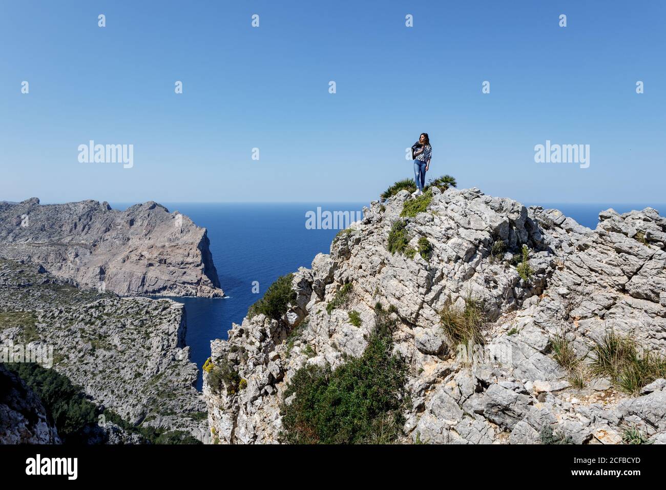 Young Woman standing on cliff Stock Photo - Alamy