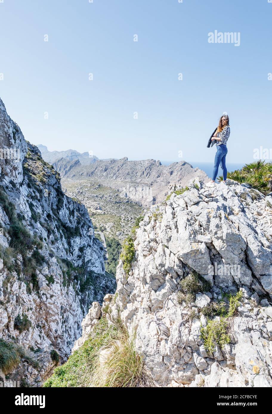 Young Woman standing on cliff Stock Photo - Alamy