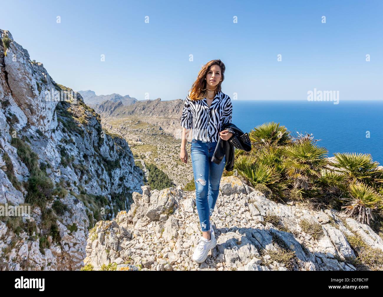 Young Woman standing on cliff Stock Photo - Alamy