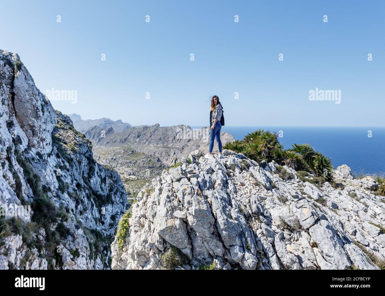 Young Woman standing on cliff Stock Photo - Alamy