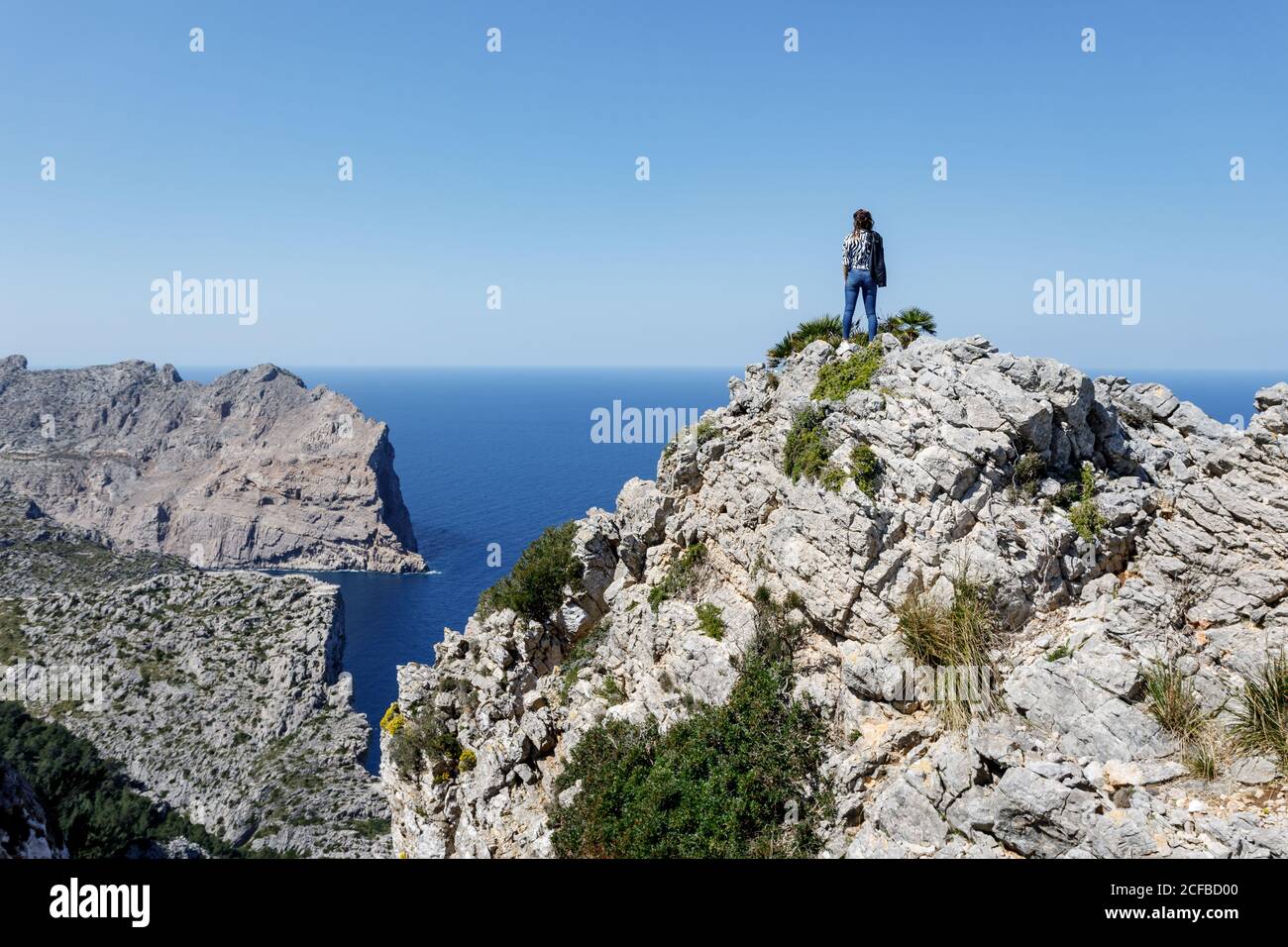 Young Woman standing on cliff Stock Photo - Alamy