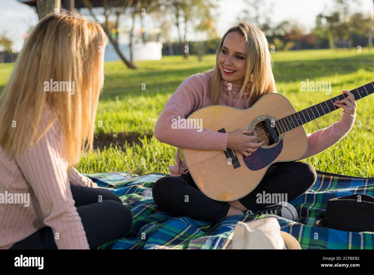 Two girls playing guitar singing hi-res stock photography and images ...