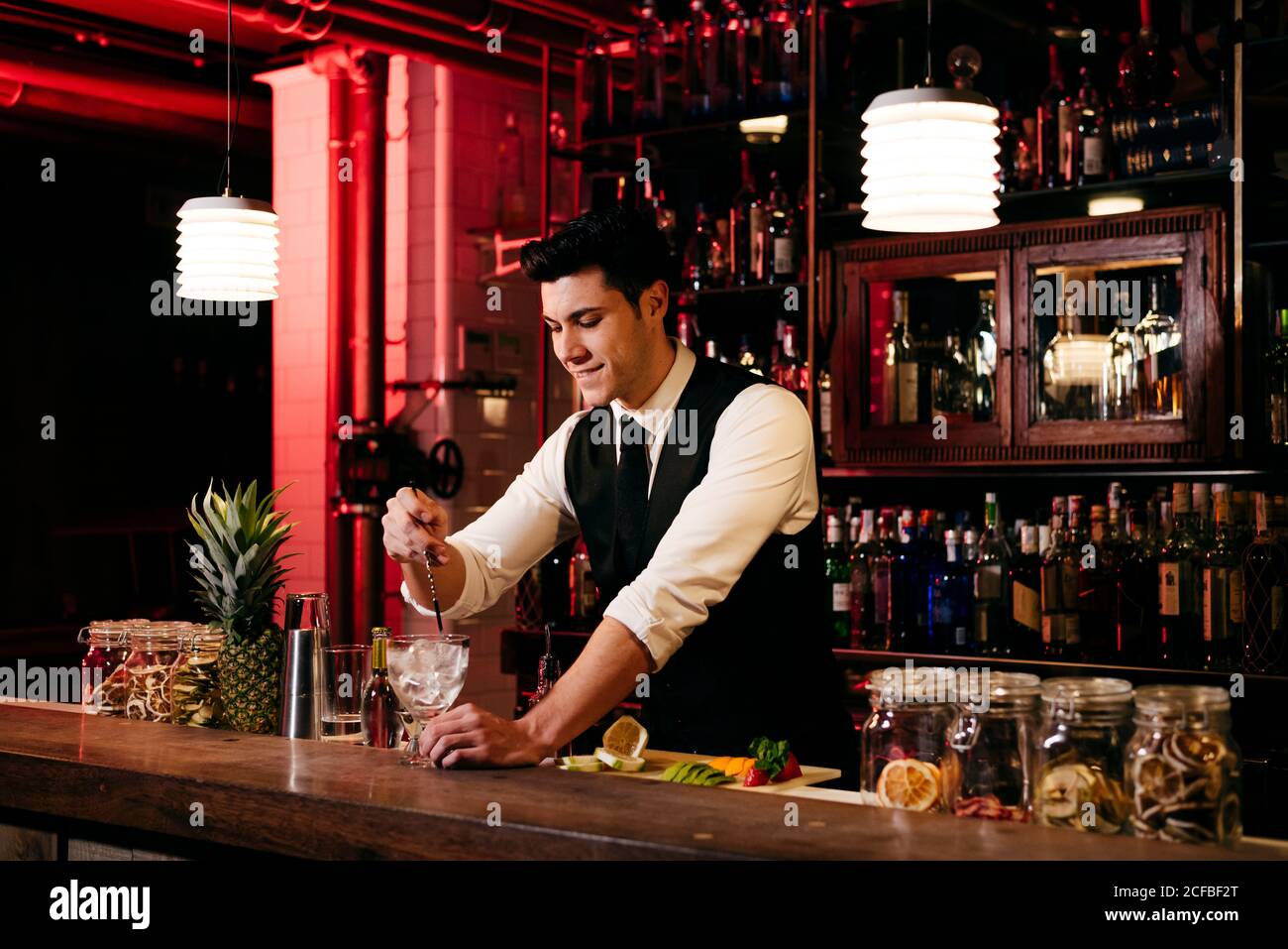 Bartender behind the bar preparing drinks hi-res stock photography and ...