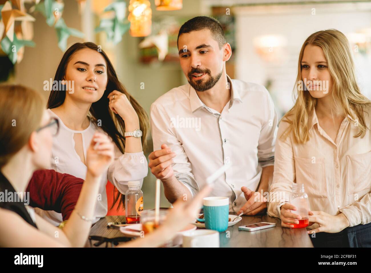 Casual business team eating together in the office Stock Photo - Alamy