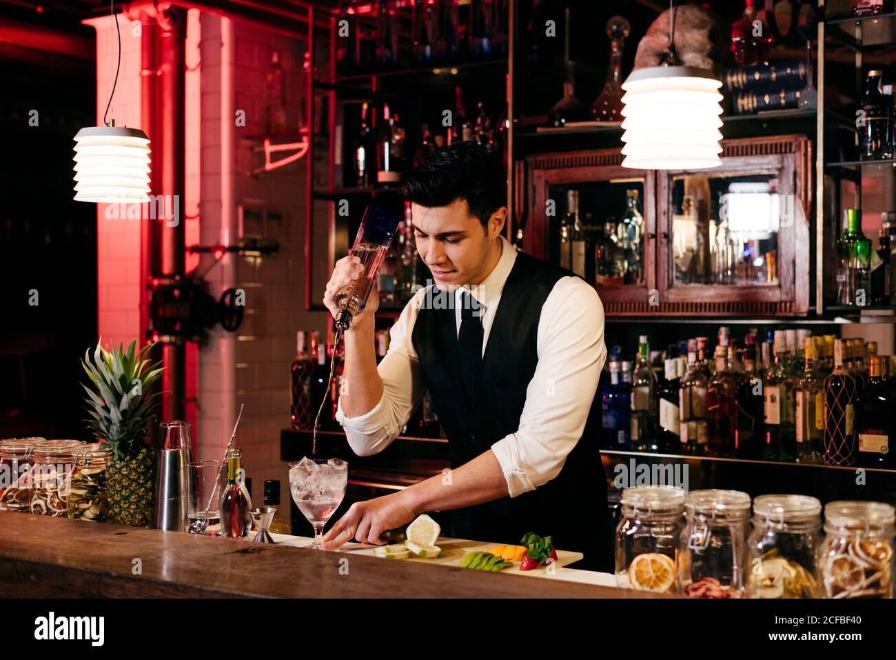 Bartender behind the bar preparing drinks hi-res stock photography and ...