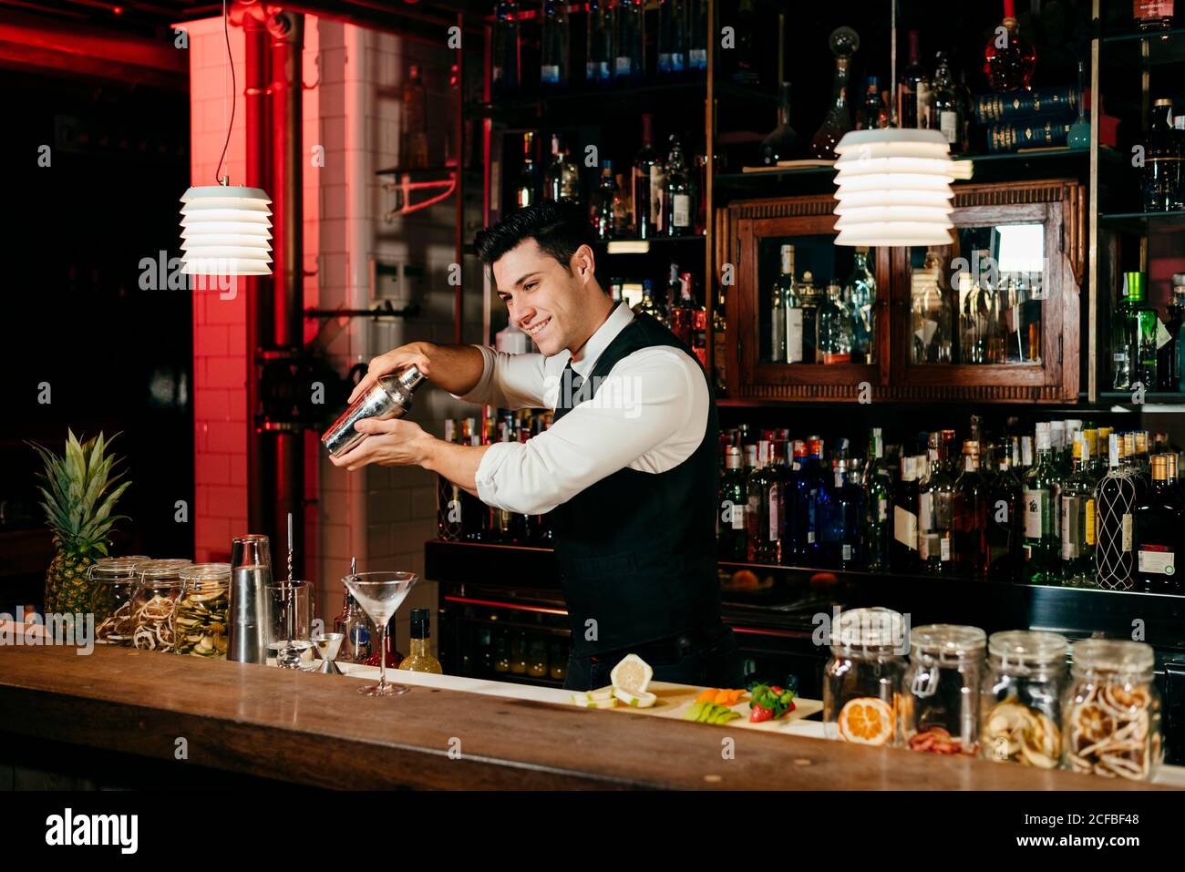 Bartender behind the bar preparing drinks hi-res stock photography and ...