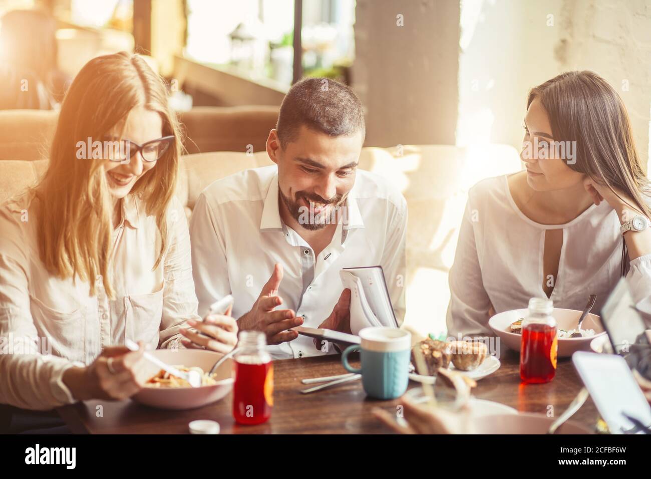 Business Colleagues Eating Meal Together and Discussing of Work Stock ...