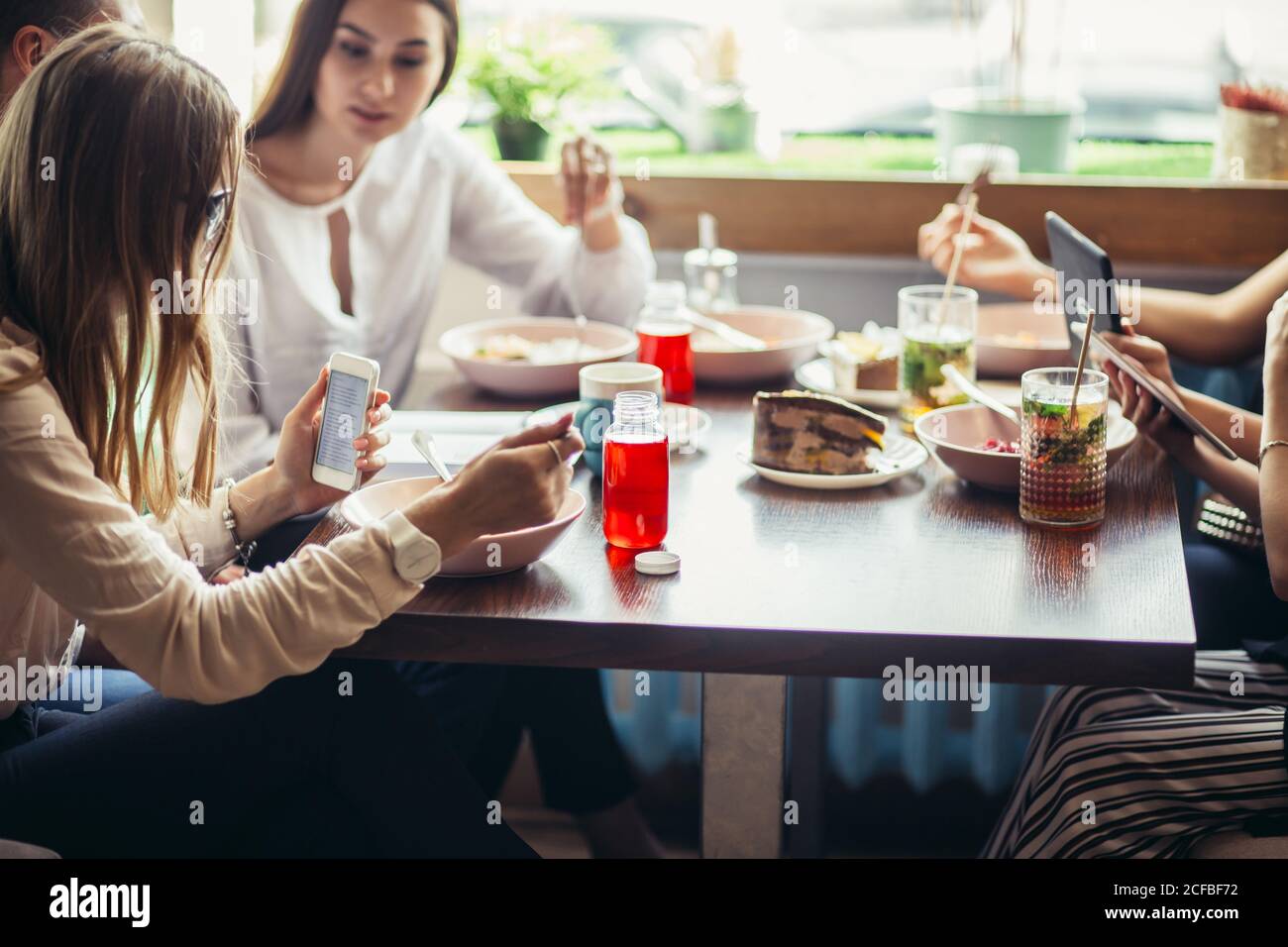 Group Enjoying Business team Lunch In Delicatessen Stock Photo - Alamy