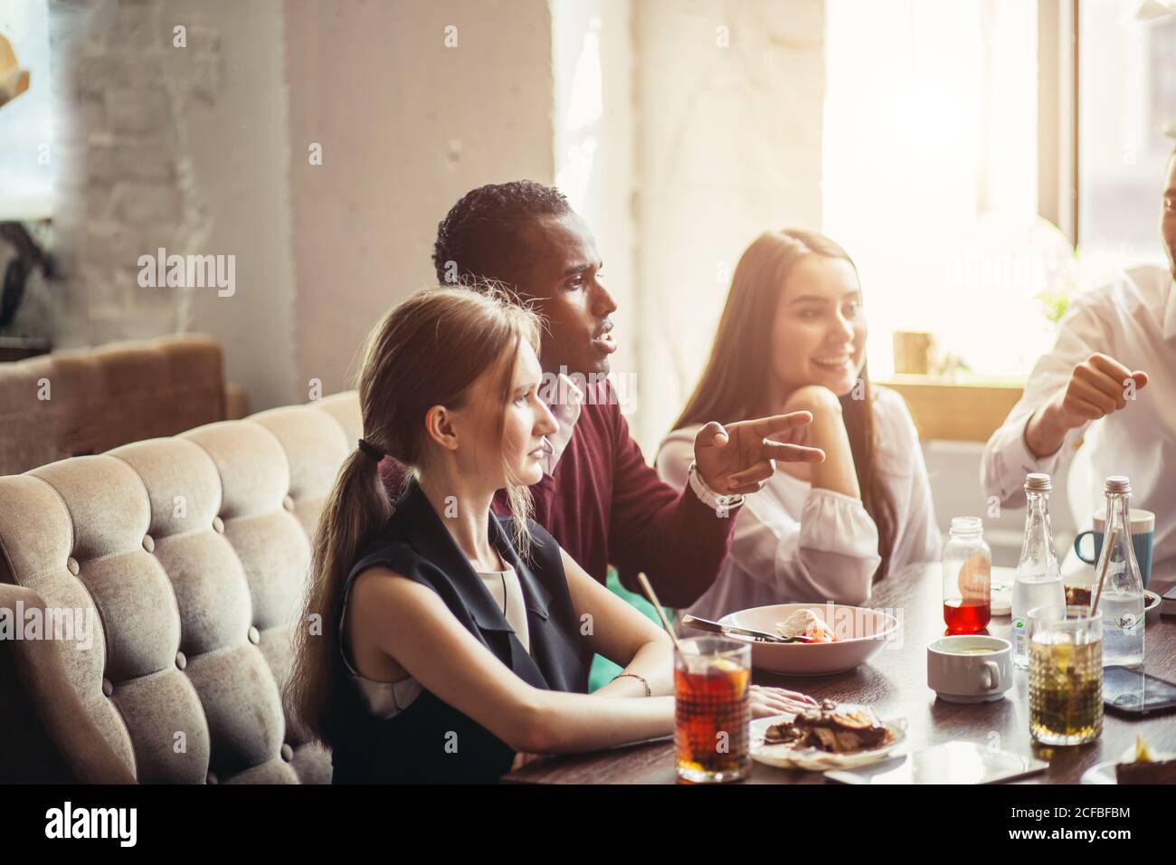Group Enjoying Business team Lunch In Delicatessen Stock Photo - Alamy