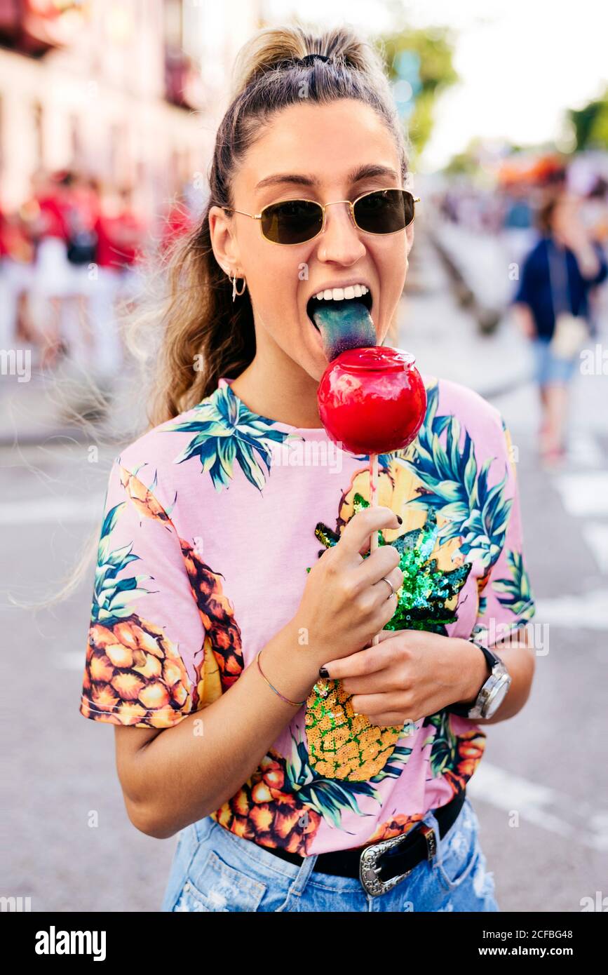 Cheerful lady having fun enjoying sweet candy apple Stock Photo - Alamy