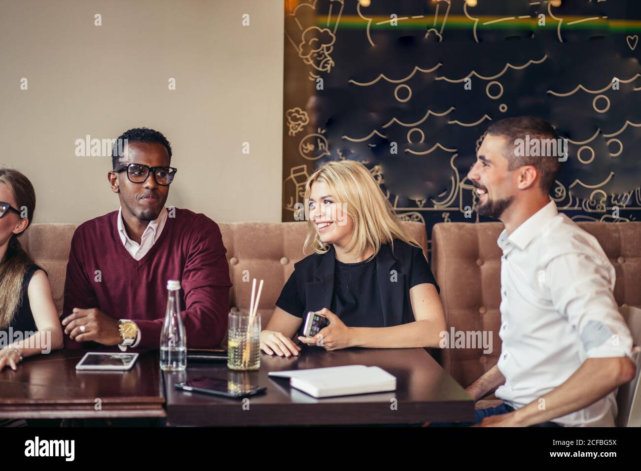 Group Enjoying Business team Lunch In Delicatessen Stock Photo - Alamy