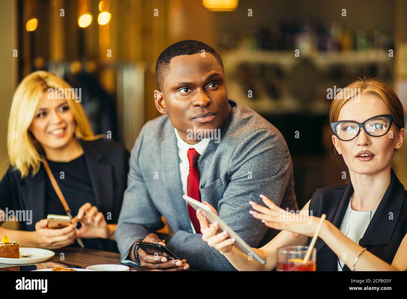 business people meeting in modern restaurant, colleagues having dinner ...
