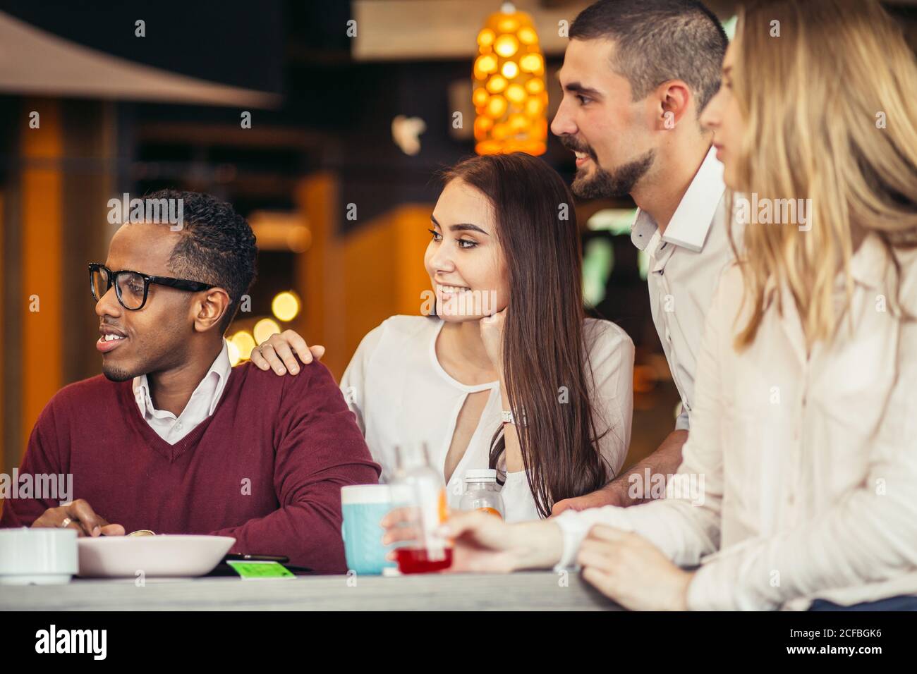 Group Enjoying Business team Lunch In Delicatessen Stock Photo - Alamy