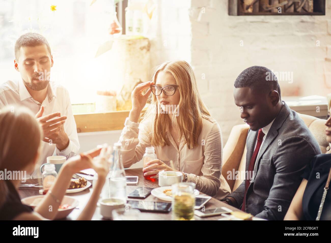 Business Colleagues Eating Meal Together and Discussing of Work Stock ...