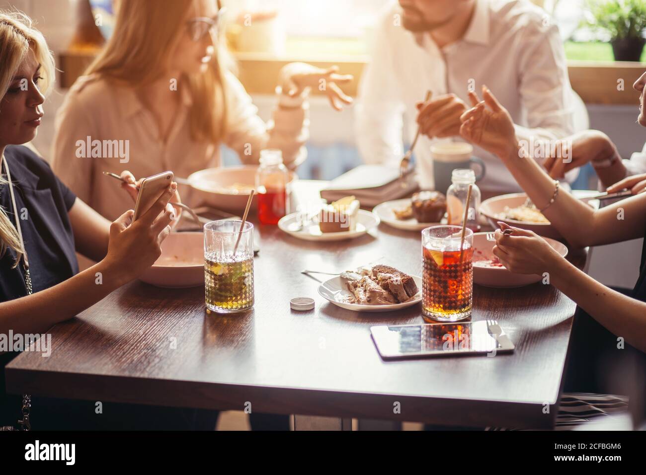 Group Enjoying Business team Lunch In Delicatessen Stock Photo - Alamy