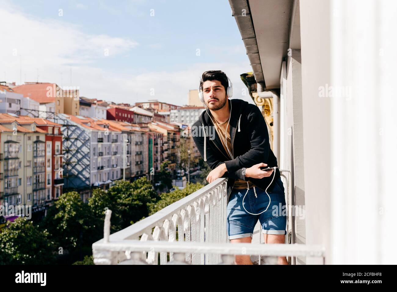 Man sitting on balcony railing hi-res stock photography and images - Alamy